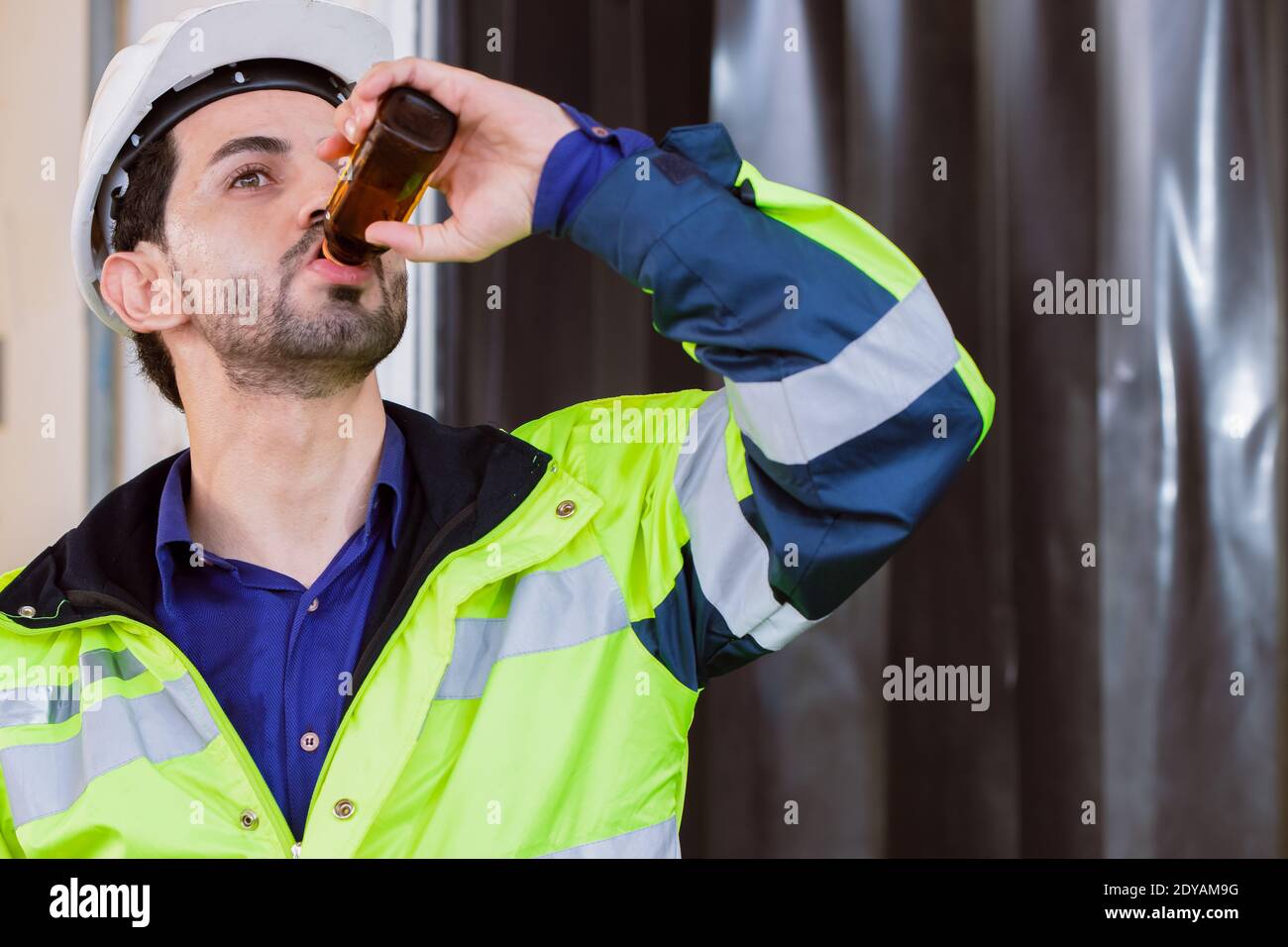 worker drinking energy drink for refresh tired after working hard work ...