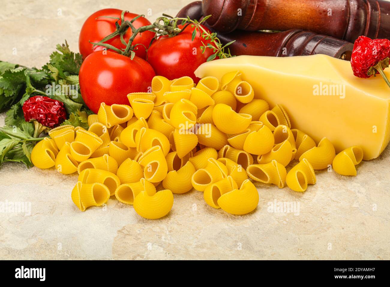Italian pasta - raw pipe rigate served vegetables Stock Photo - Alamy
