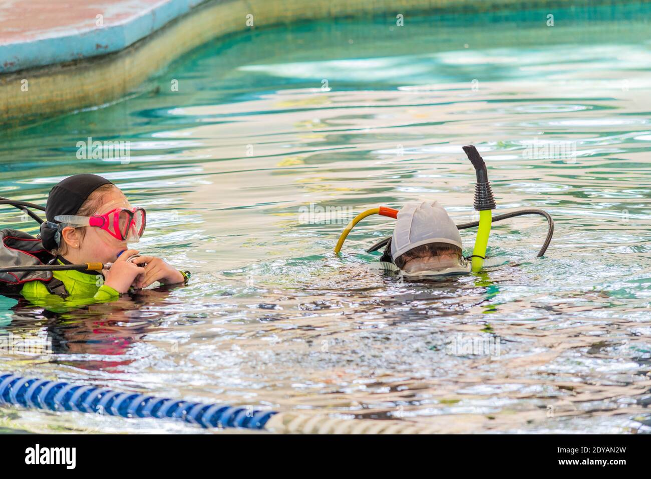 teacher and student in diving classes the student is adjusting her ...