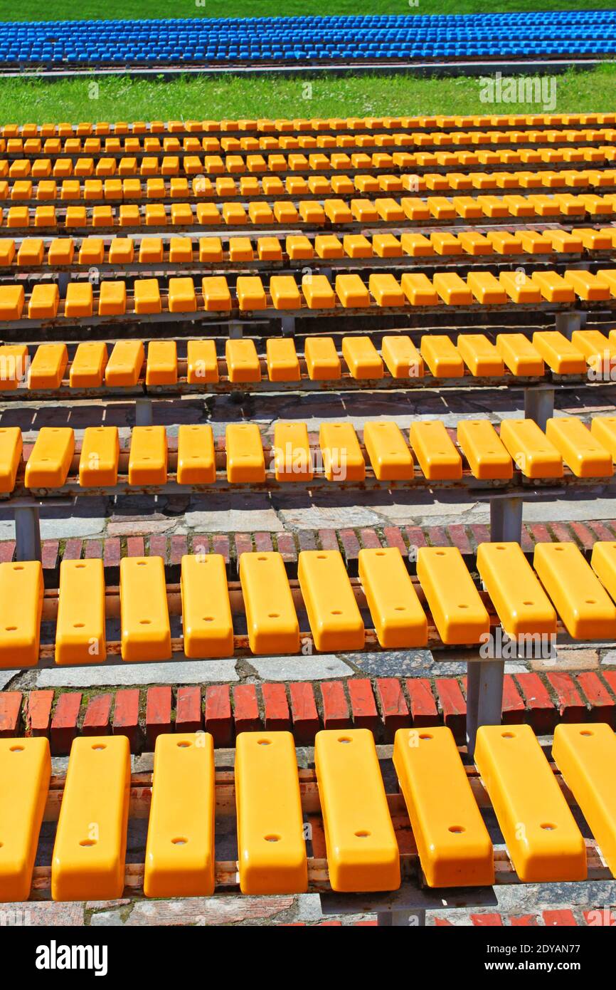 Bright yellow and blue seats in rows Stock Photo - Alamy