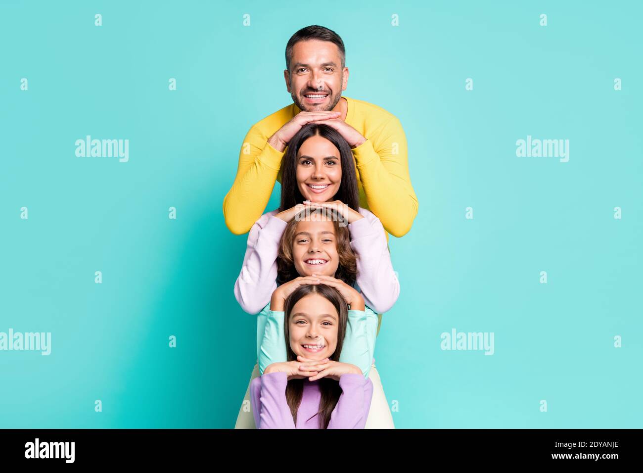 Photo portrait of full family stacking heads on top of each other ...