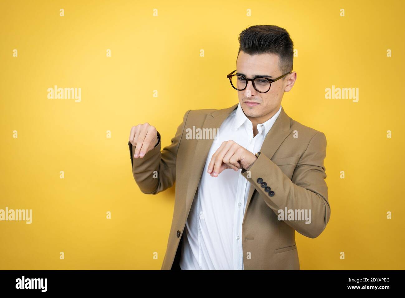 Young business man over isolated yellow background disgusted expression ...