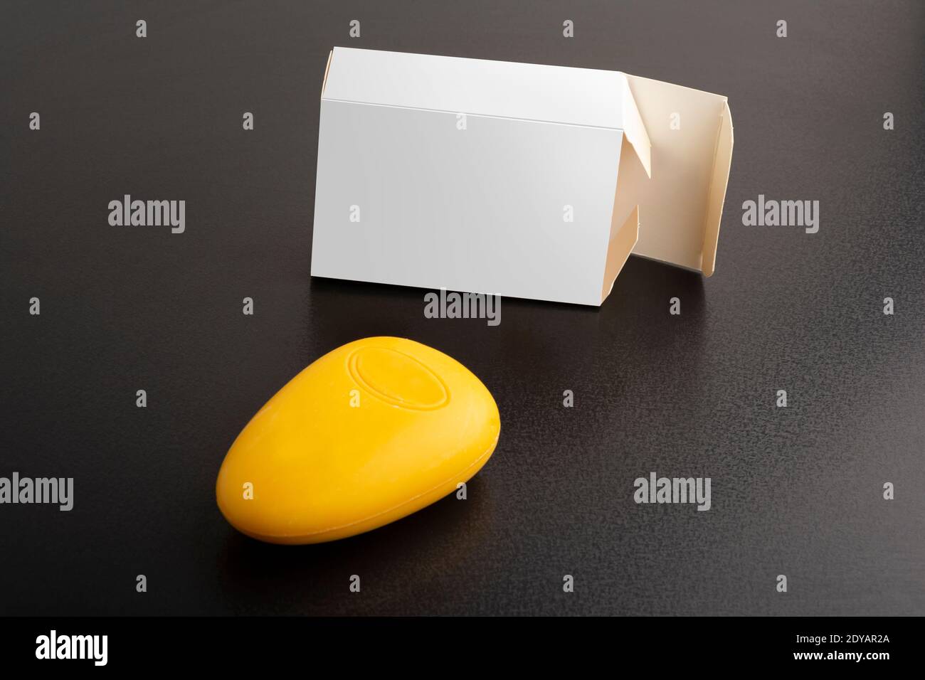 Opened yellow soap package on black surface, editable mock-up series ...