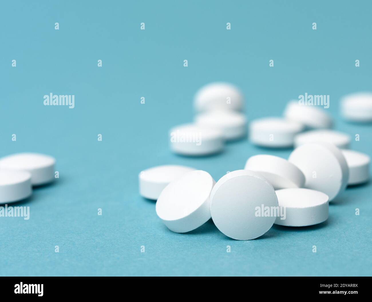 White round pill for healthcare. Medical treatment, bue background ...