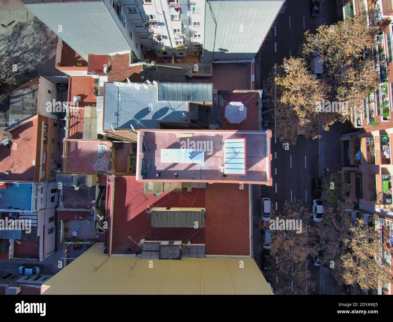 A top view of colorful rooftops of an apartment building with umbrellas ...