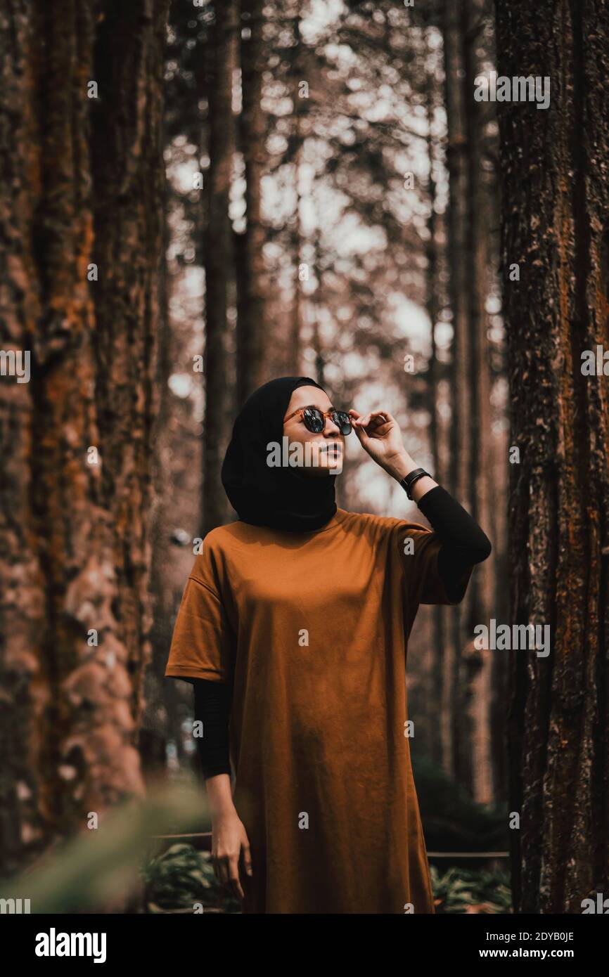 Standing Against Trees In Forest Stock Photo - Alamy