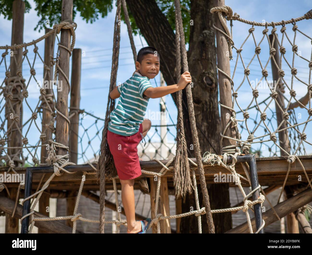 Boys climbing a rope in playground hi-res stock photography and images ...