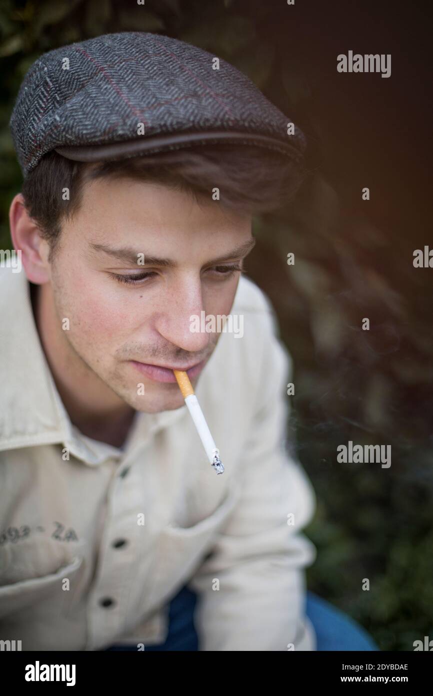 Young Man Smoking Cigarette Stock Photo - Alamy
