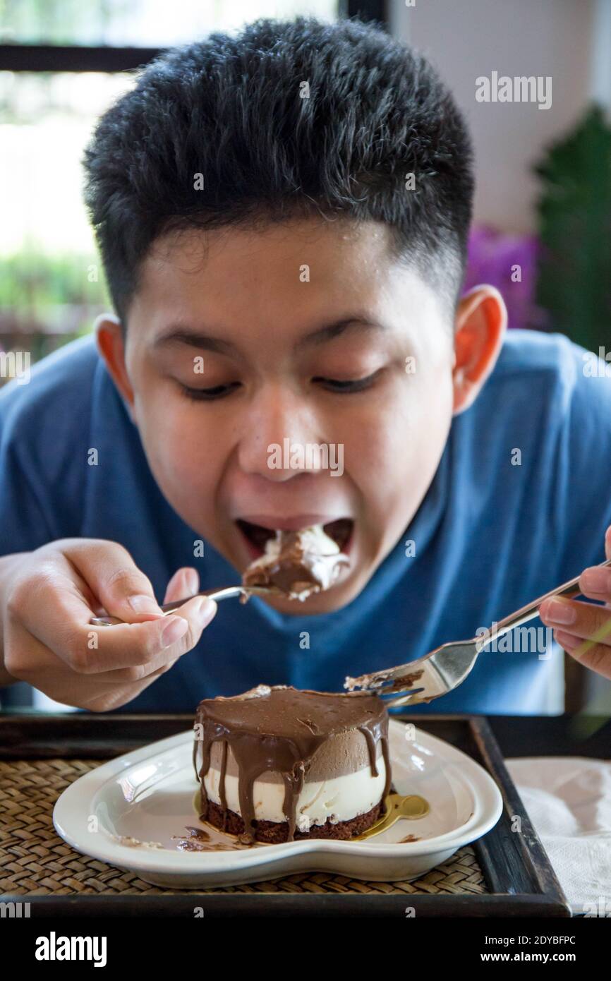 Indian child eating cake hi-res stock photography and images - Alamy