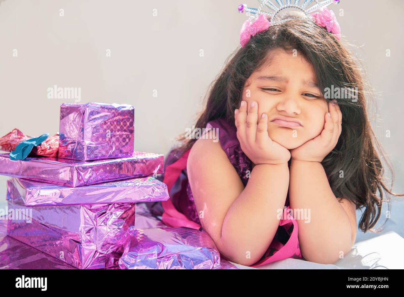 Cute child unhappy with bad birthday present. Portrait of sad little ...