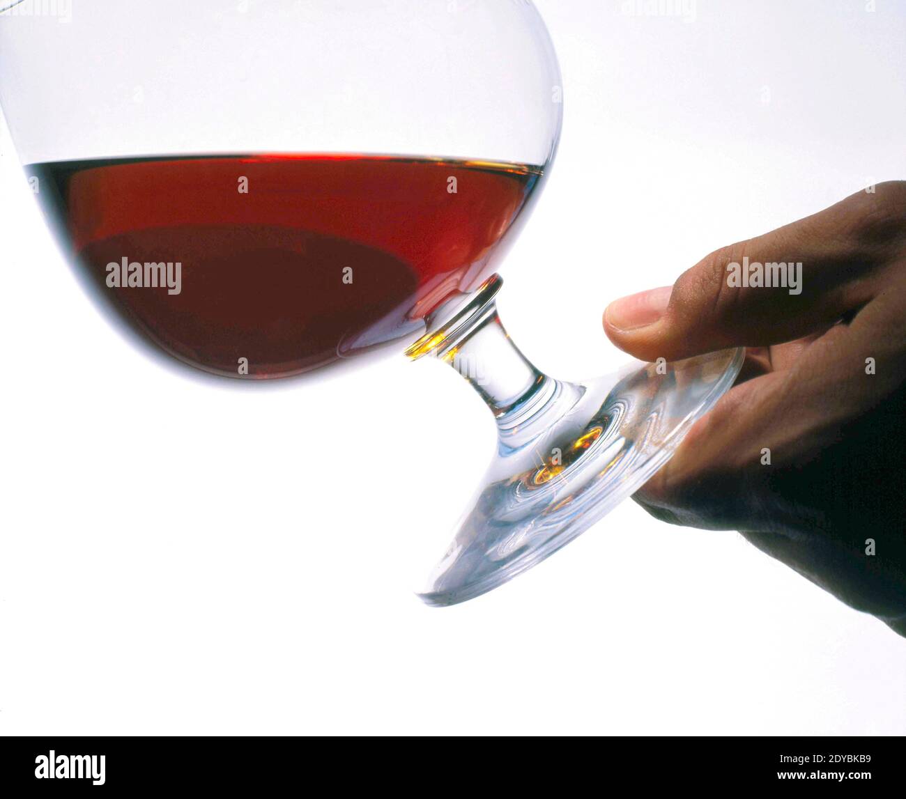 Hand holding wine glass on white background Stock Photo - Alamy