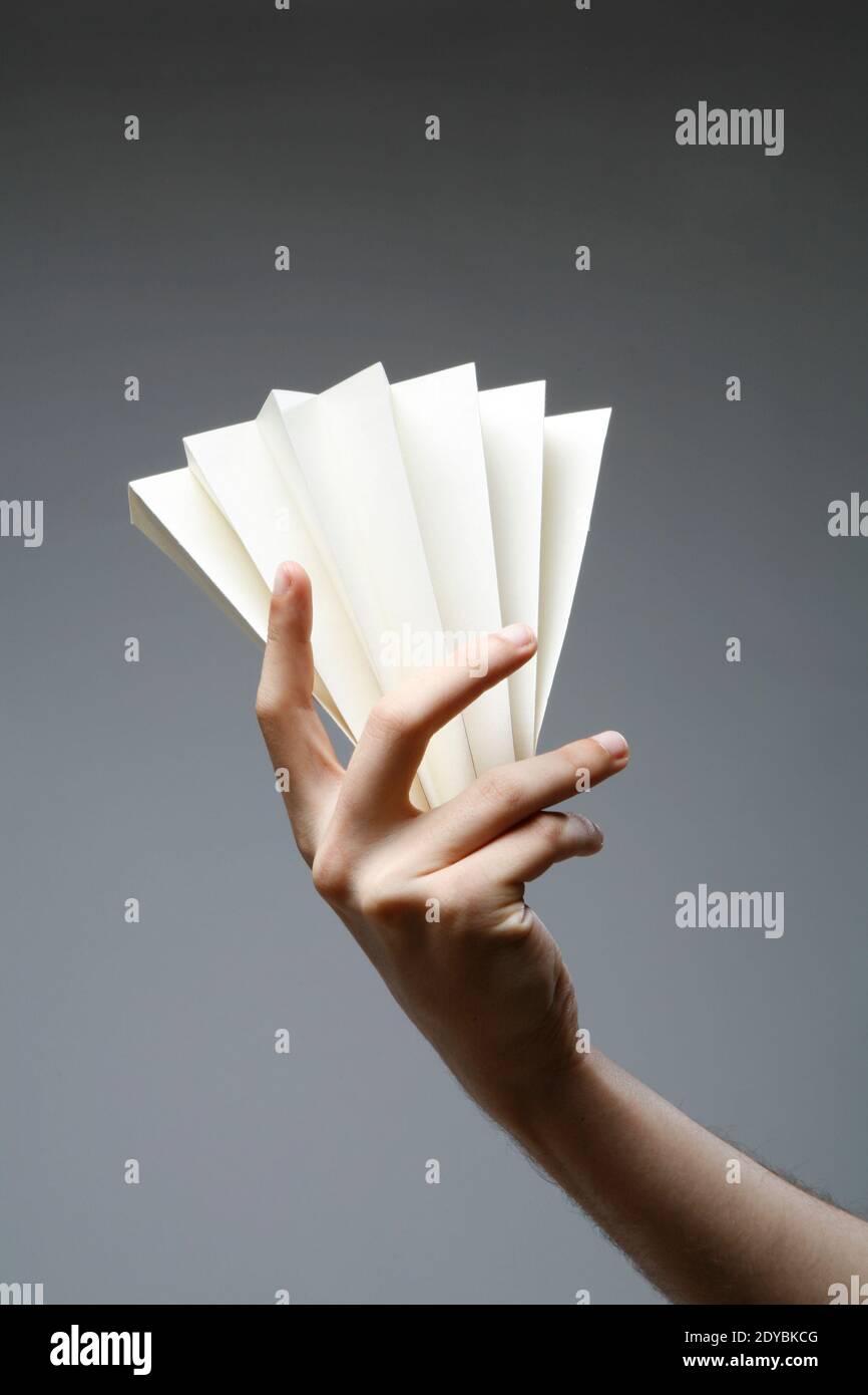 Hand with paper on grey background. Origami concept Stock Photo - Alamy