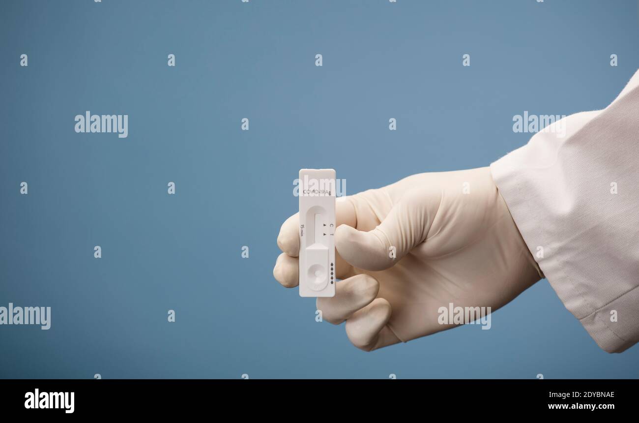 Doctor containing a COVID-19 2019-nCoV viral disease test kit. Sars-cov ...