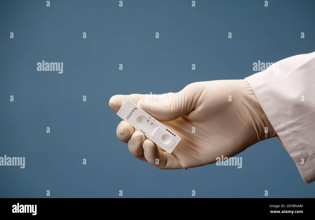 Doctor containing a COVID-19 2019-nCoV viral disease test kit. Sars-cov ...
