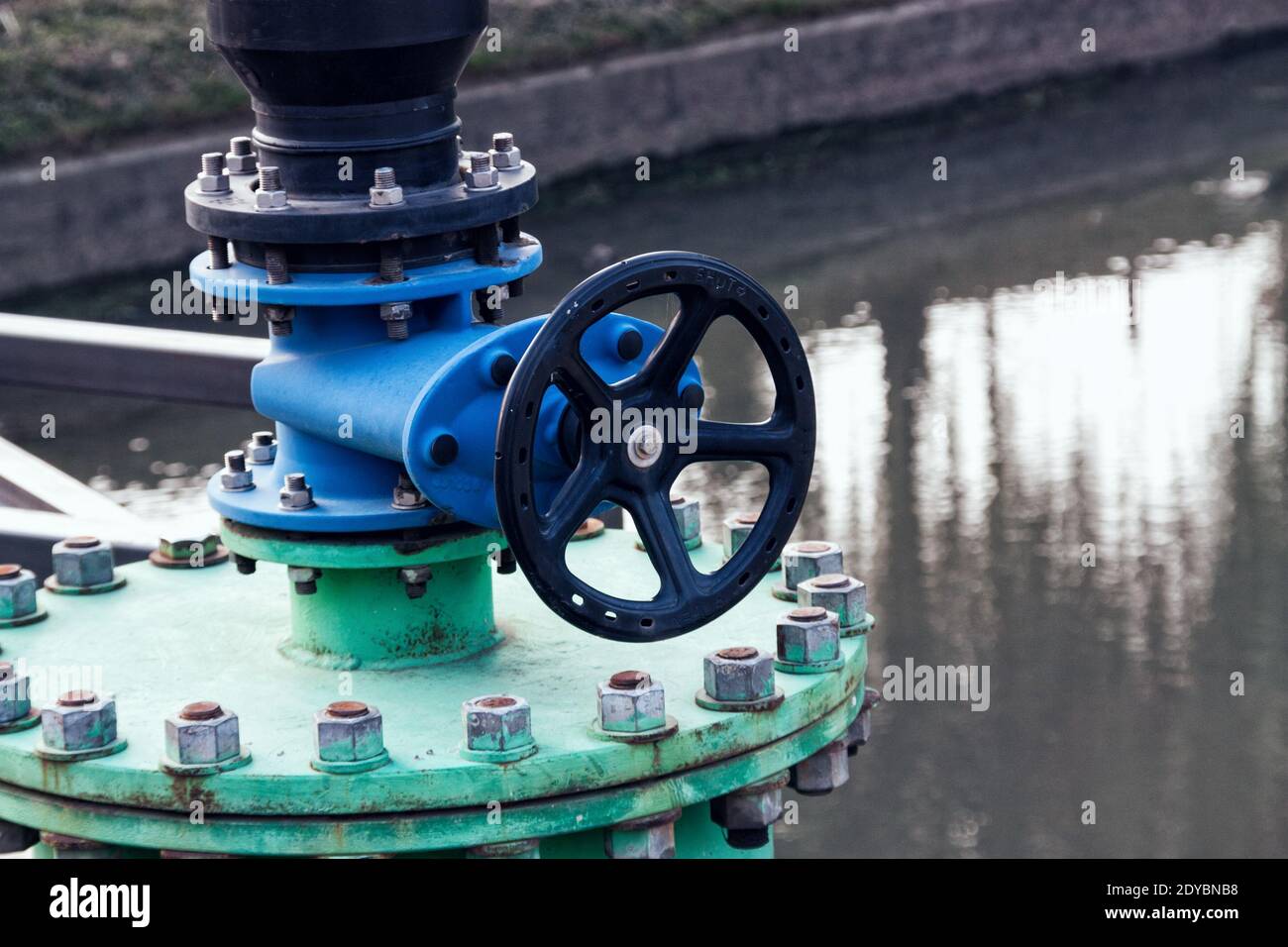 Industrial water tap on the creek damb Stock Photo - Alamy