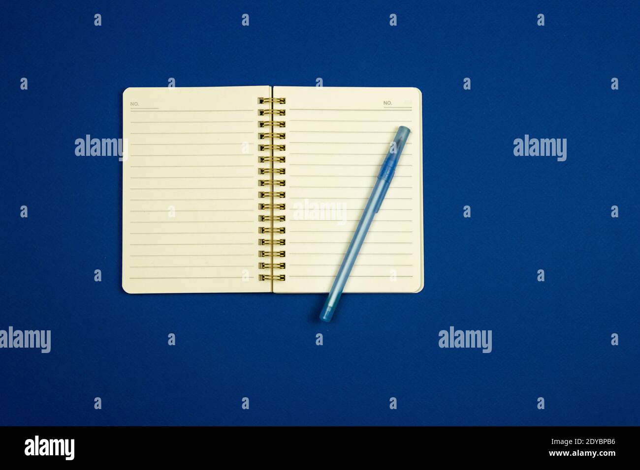 Notepad for notes and pen on a simple blue background, flat design, top ...