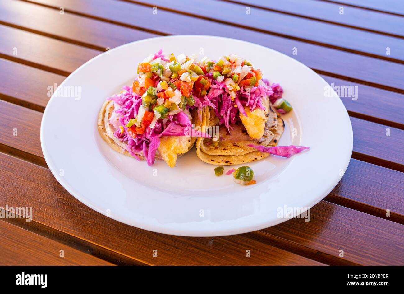 Red Snapper Fish Tacos on White Plate and Wood Table Stock Photo - Alamy