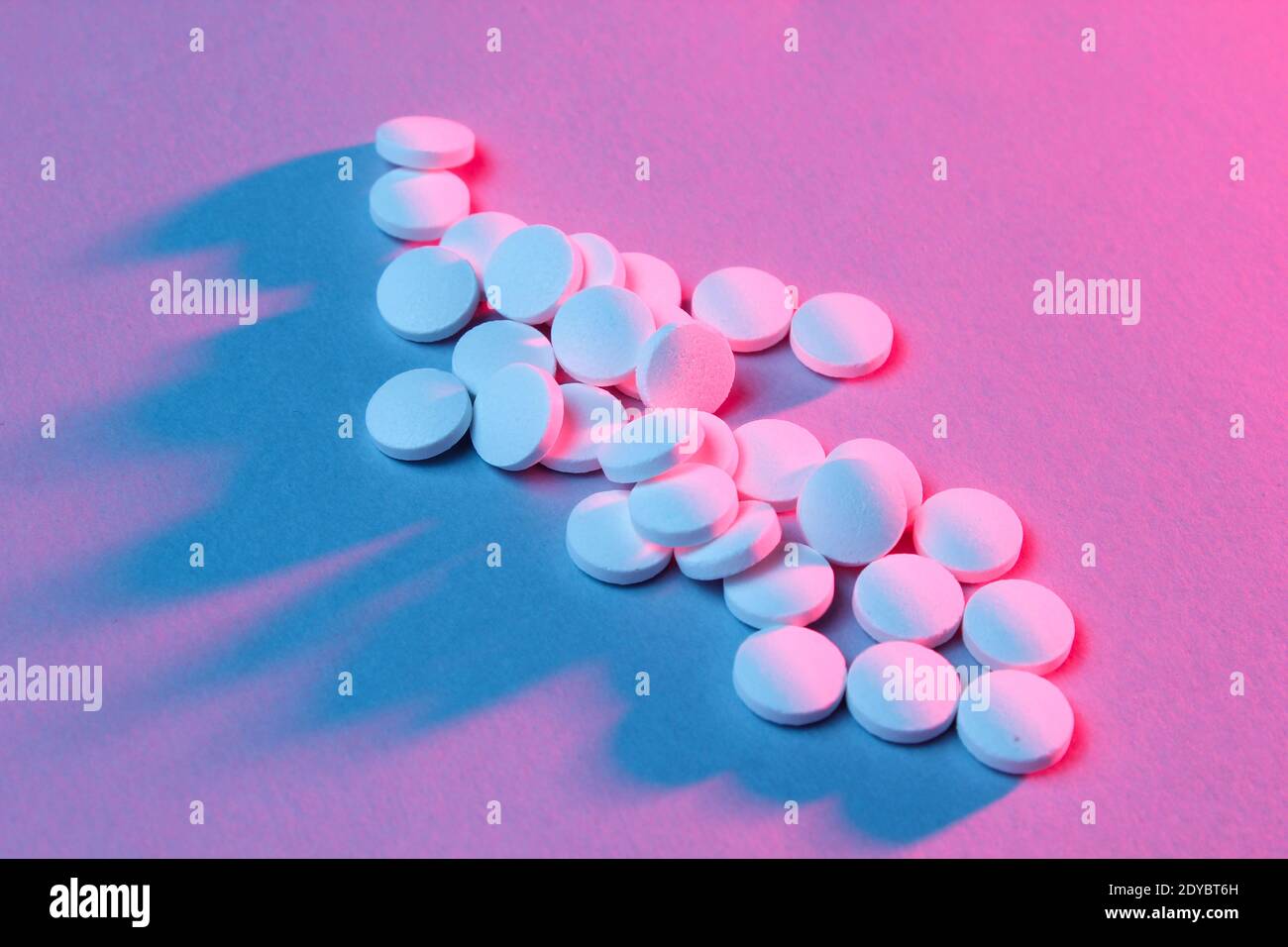 Addiction. The concept of dependence. Many white pills with red-blue ...