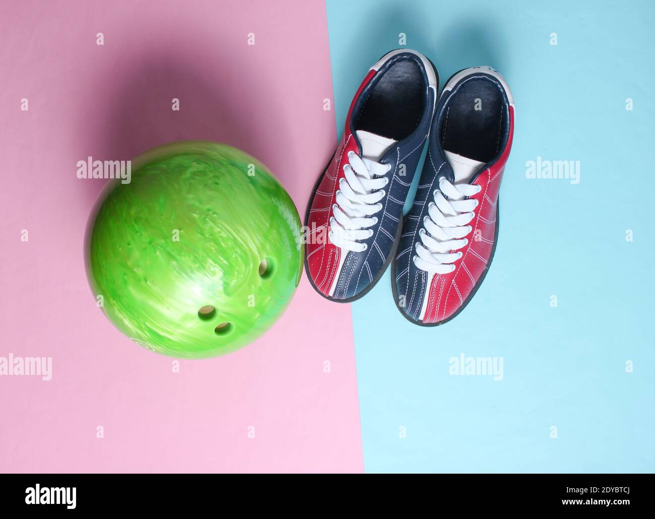 Bowling shoes and bowling ball on a pink-blue pastel background. Indoor ...