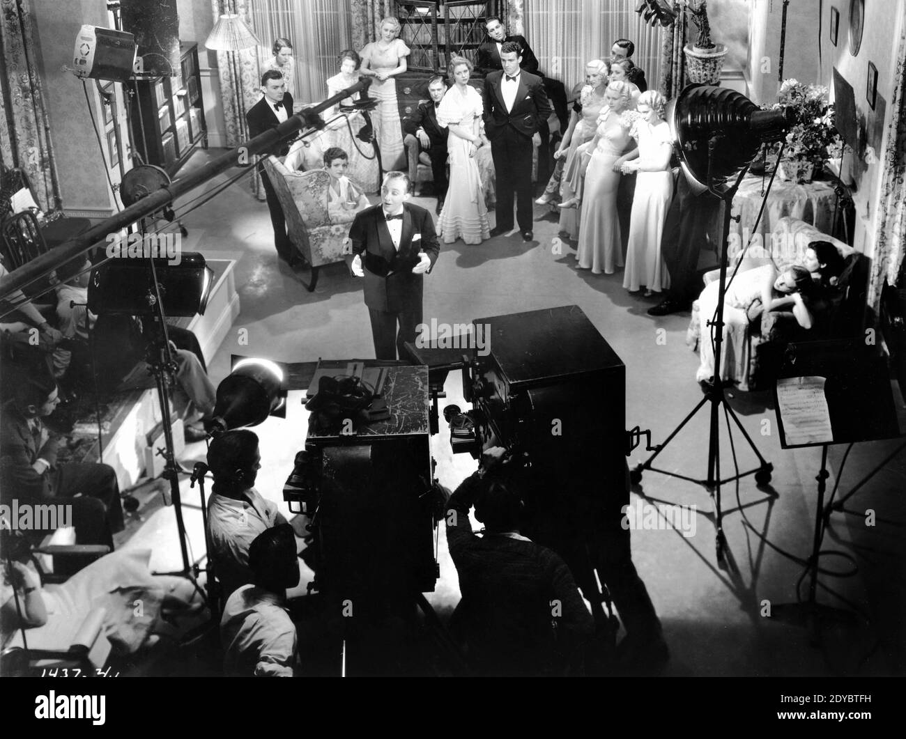 BNG CROSBY performing a song for two movie cameras on set candid with ...