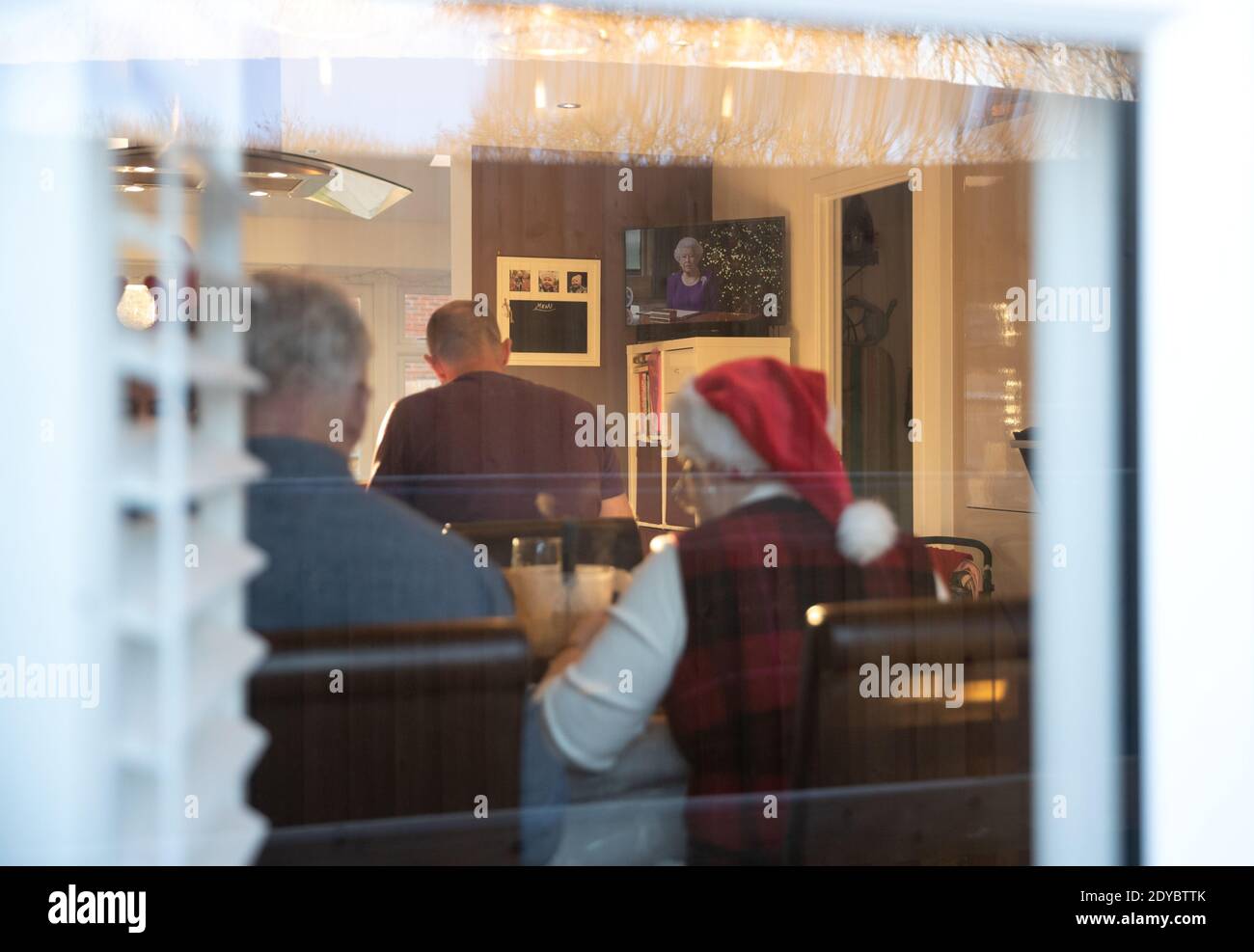 A family eat their Christmas dinner in Basingstoke, Hampshire, as Queen ...