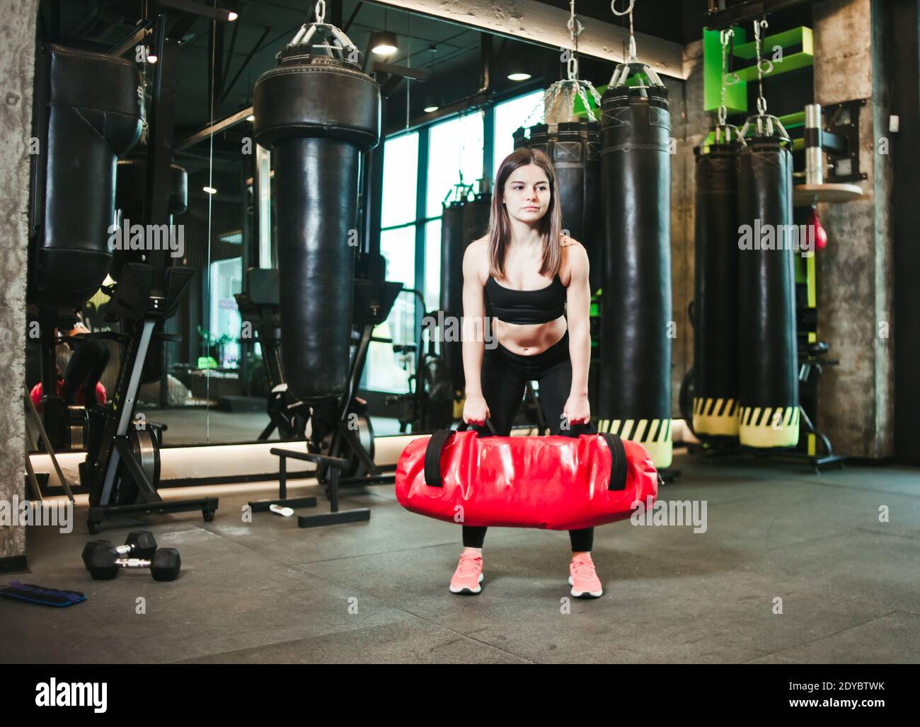 Woman lifting heavy bag hi-res stock photography and images - Alamy