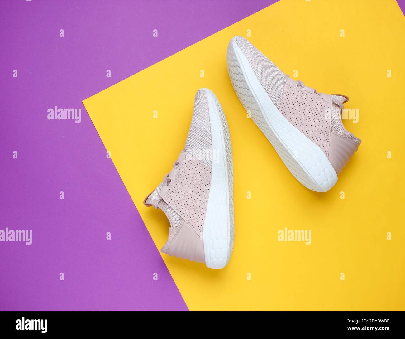 Sneakers. Sports shoes on a creative purple yellow paper background ...