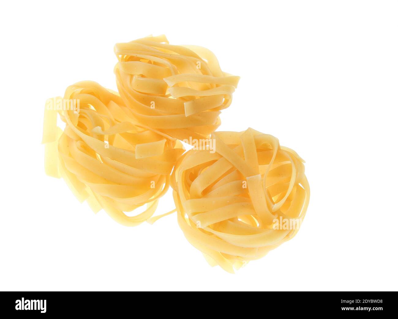 Raw dry tagliatelle noodle isolated on white background Stock Photo - Alamy