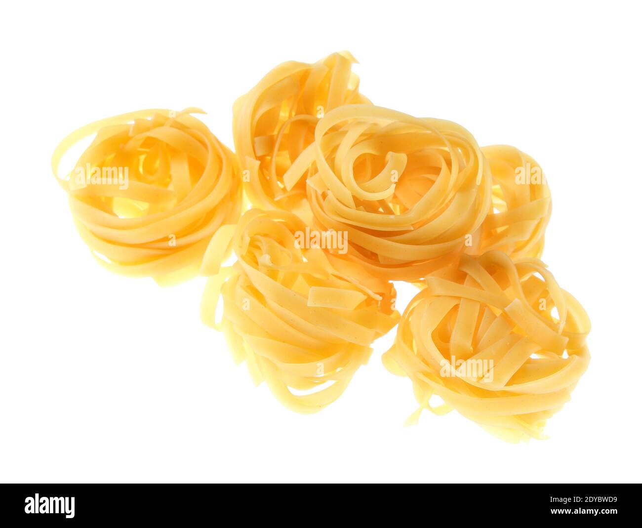 Raw dry tagliatelle noodle isolated on white background Stock Photo - Alamy