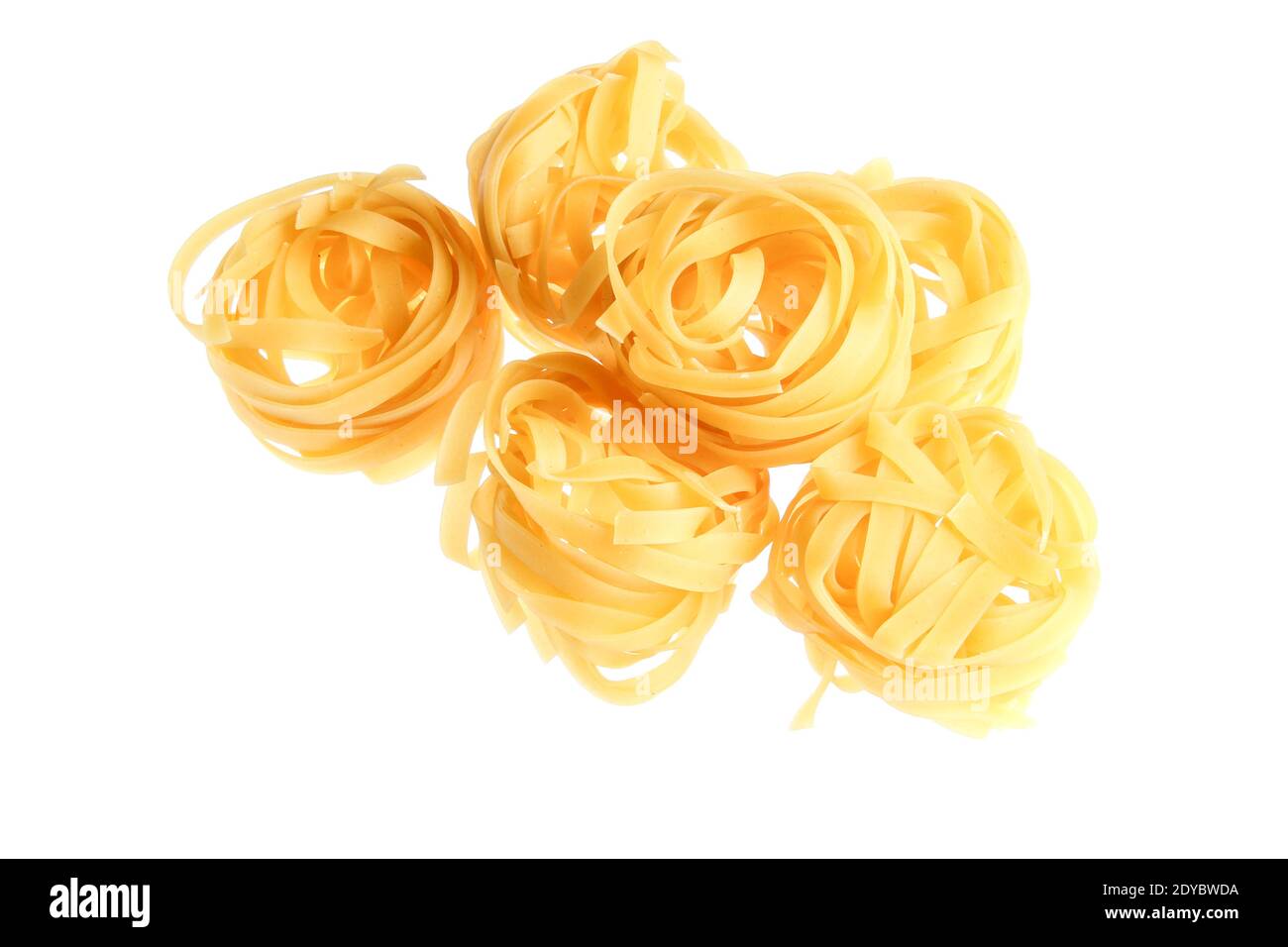 Raw dry tagliatelle noodle isolated on white background Stock Photo - Alamy