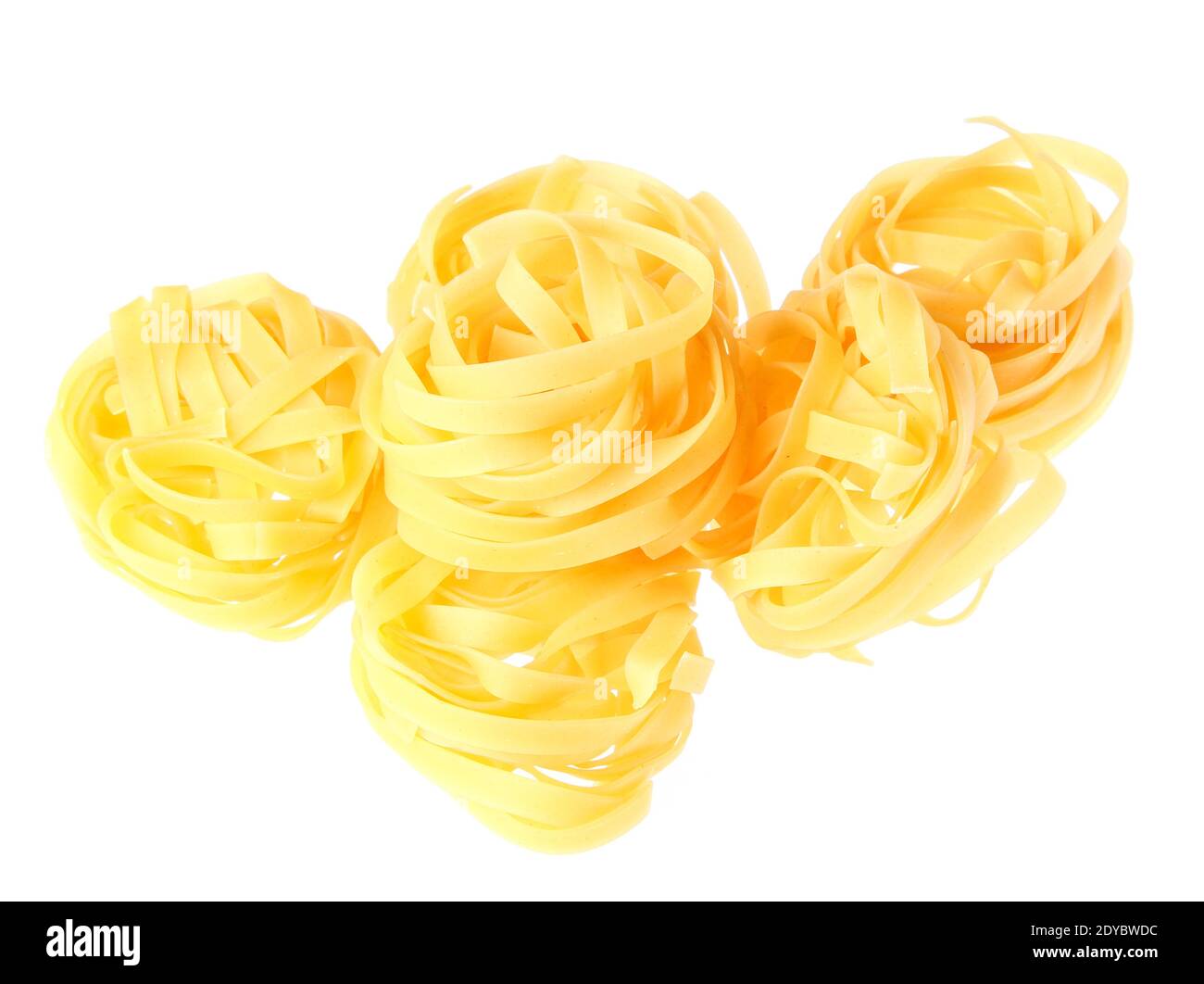 Raw dry tagliatelle noodle isolated on white background Stock Photo - Alamy