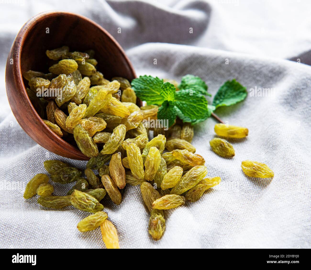 Green dried raisins on a fabric background Stock Photo - Alamy