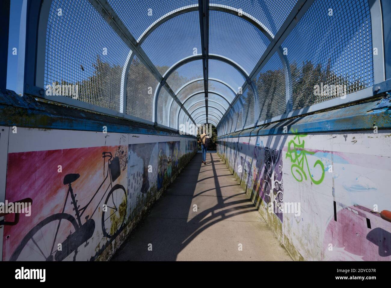 Fenced covered pedestrian walkway going over train tracks in Lewes ...