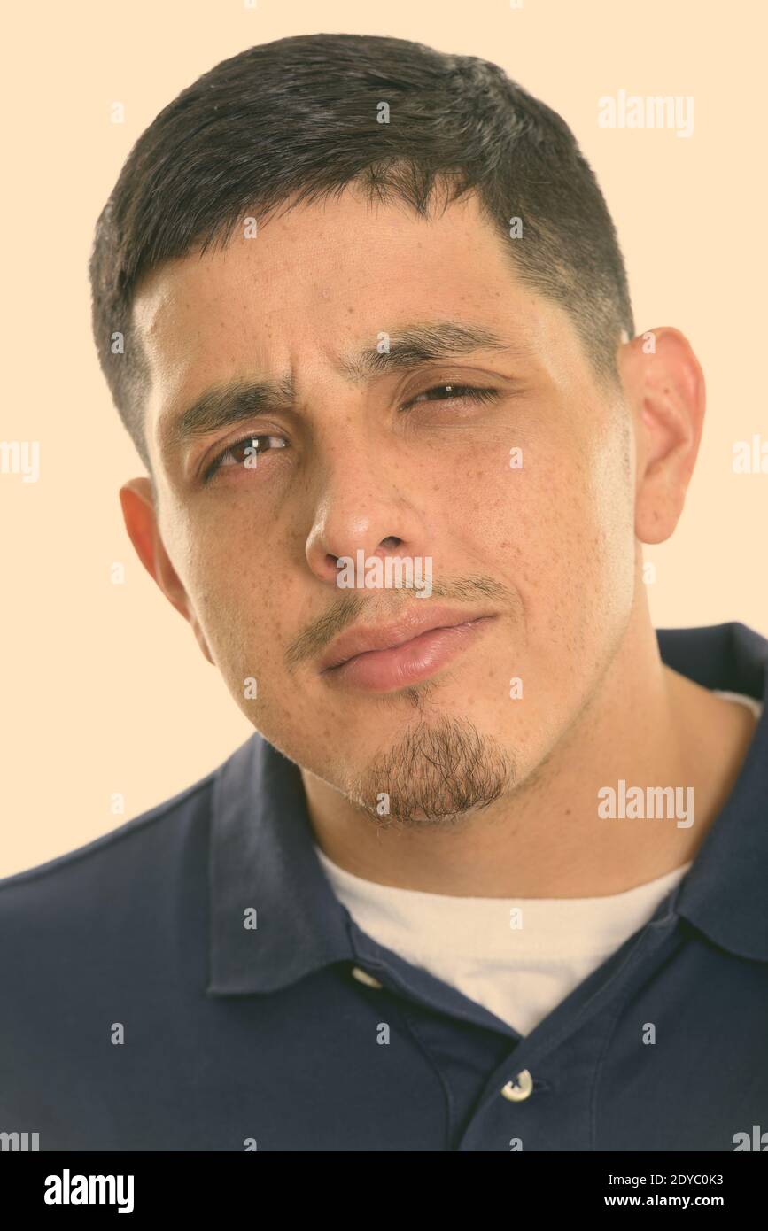 Face of young Hispanic man looking confused Stock Photo - Alamy