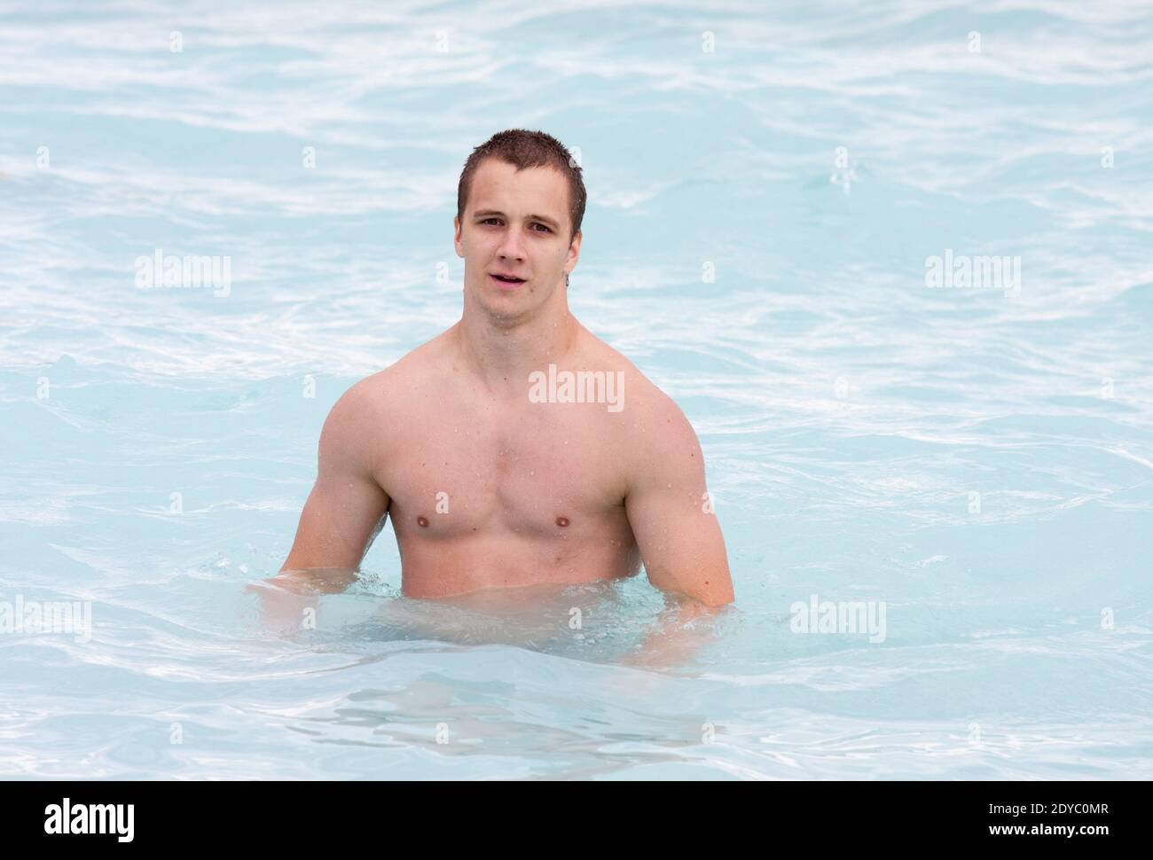 young muscular man in water Stock Photo - Alamy