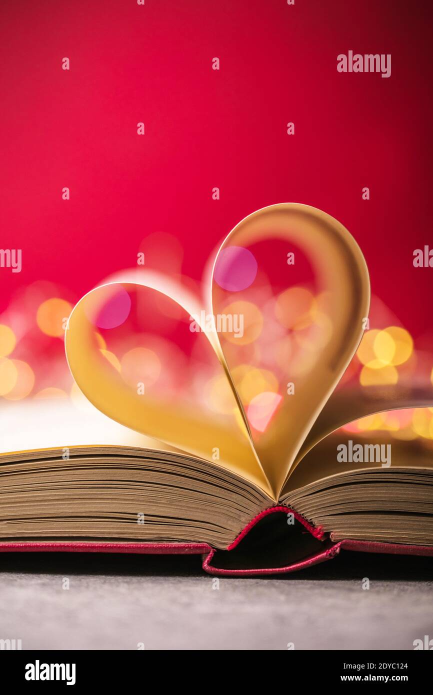 Book with love symbol on red background, heart shape from paper book ...