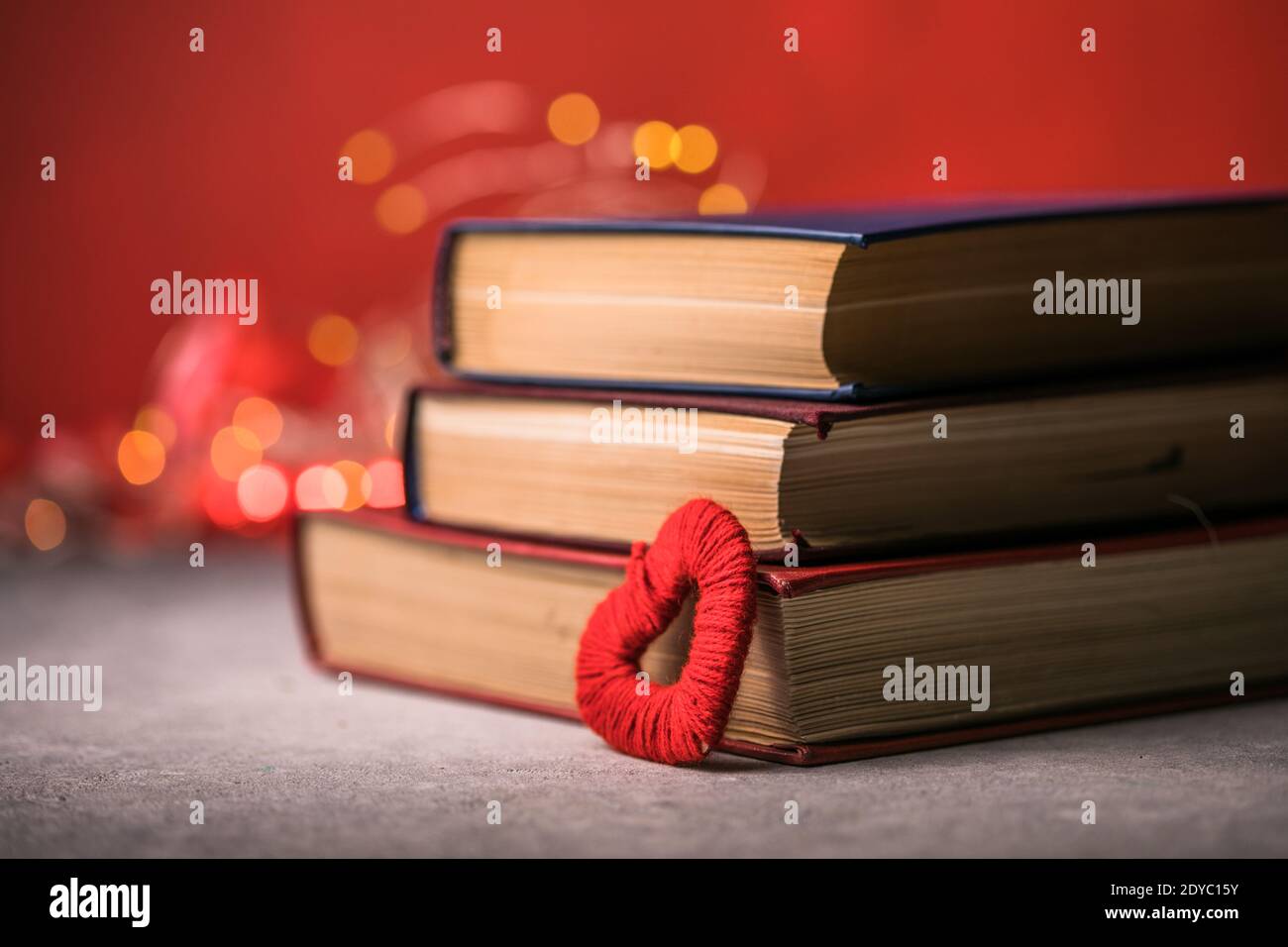 Stack of books and red heart. Romantic background with the book Stock ...