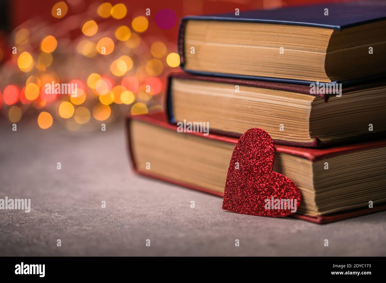 Stack of books and red heart. Romantic background with the book Stock ...