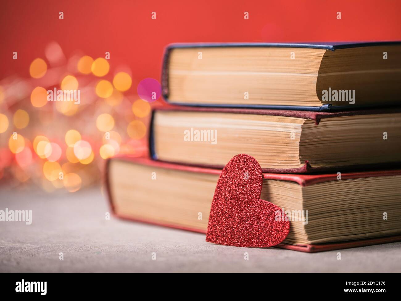 Stack of books and red heart. Romantic background with the book Stock ...