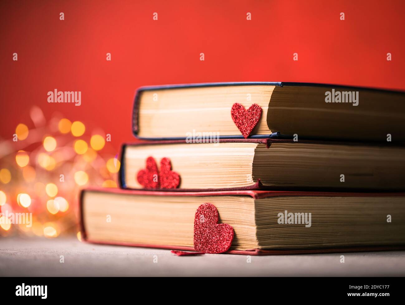 Stack of books and red heart. Romantic background with the book Stock ...