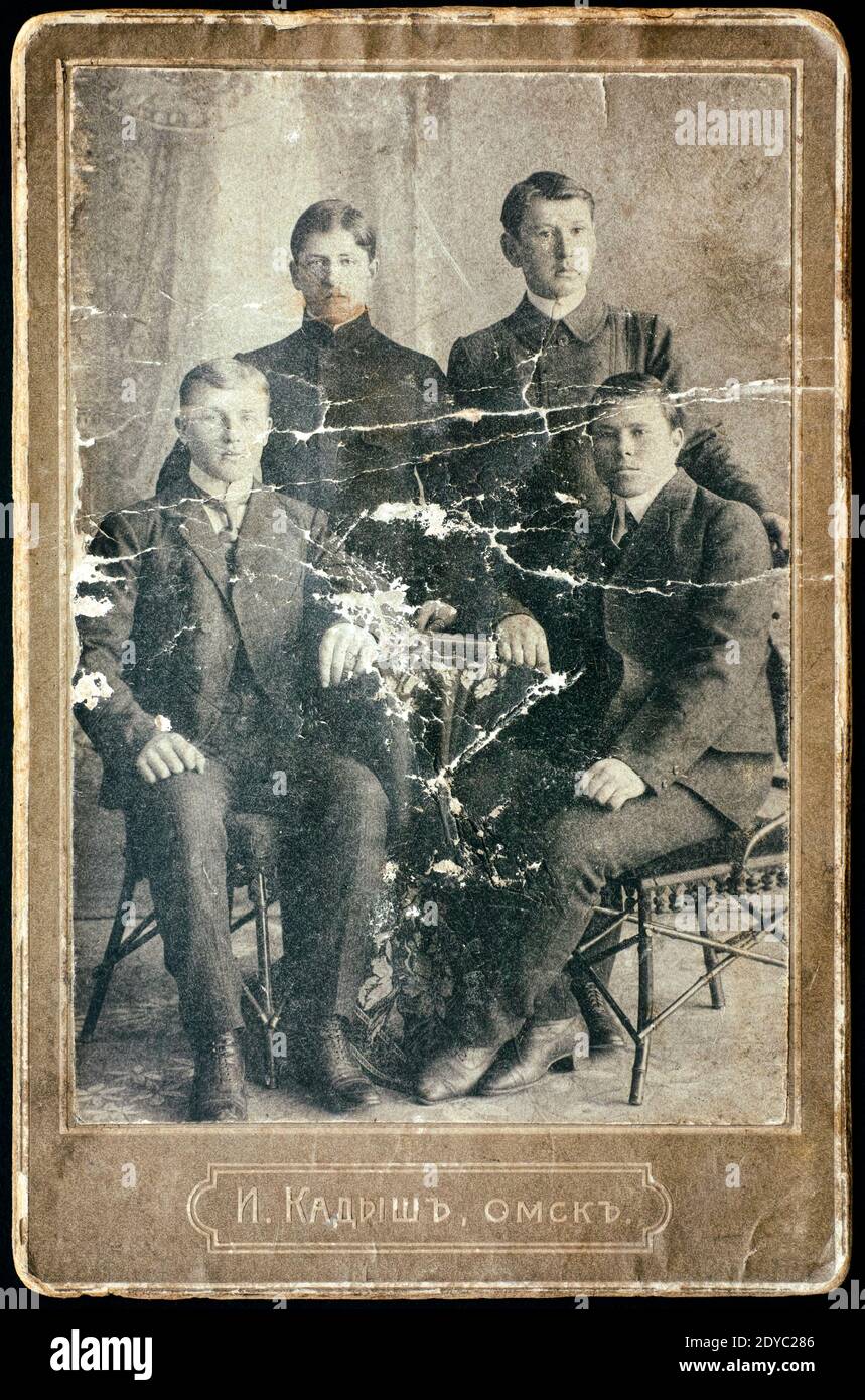 Old scratch Vintage photo of four young men in photo studio. Photo was ...