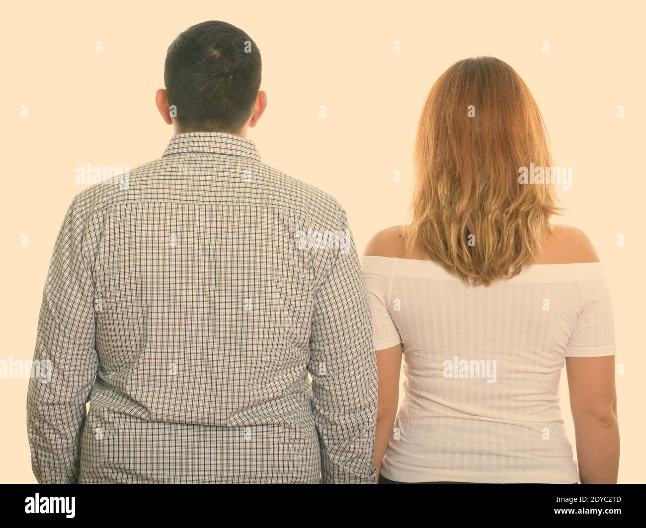 Studio shot of back view of young couple Stock Photo - Alamy