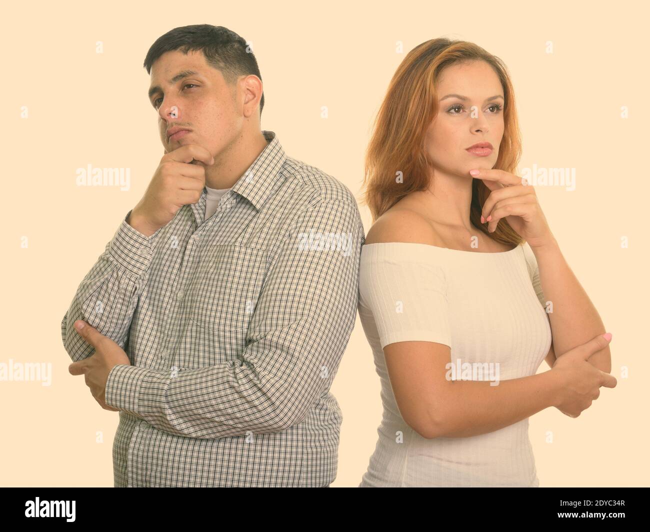 Studio shot of young couple thinking together Stock Photo - Alamy