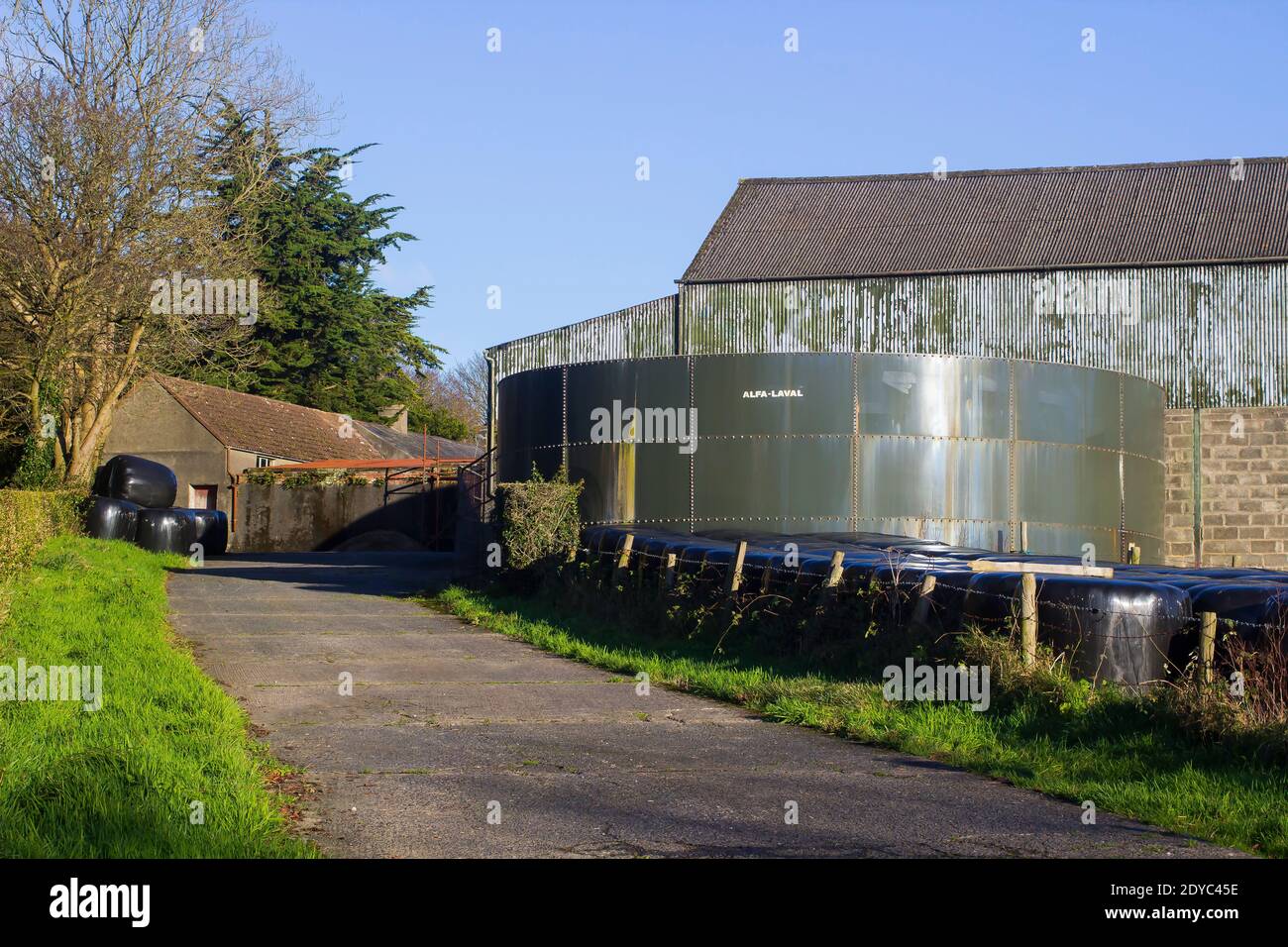 24 December 2020 A large green Alpha Laval slurry tank on a small farm ...