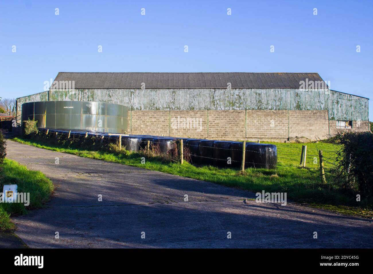 24 December 2020 A large green Alpha Laval slurry tank on a small farm ...