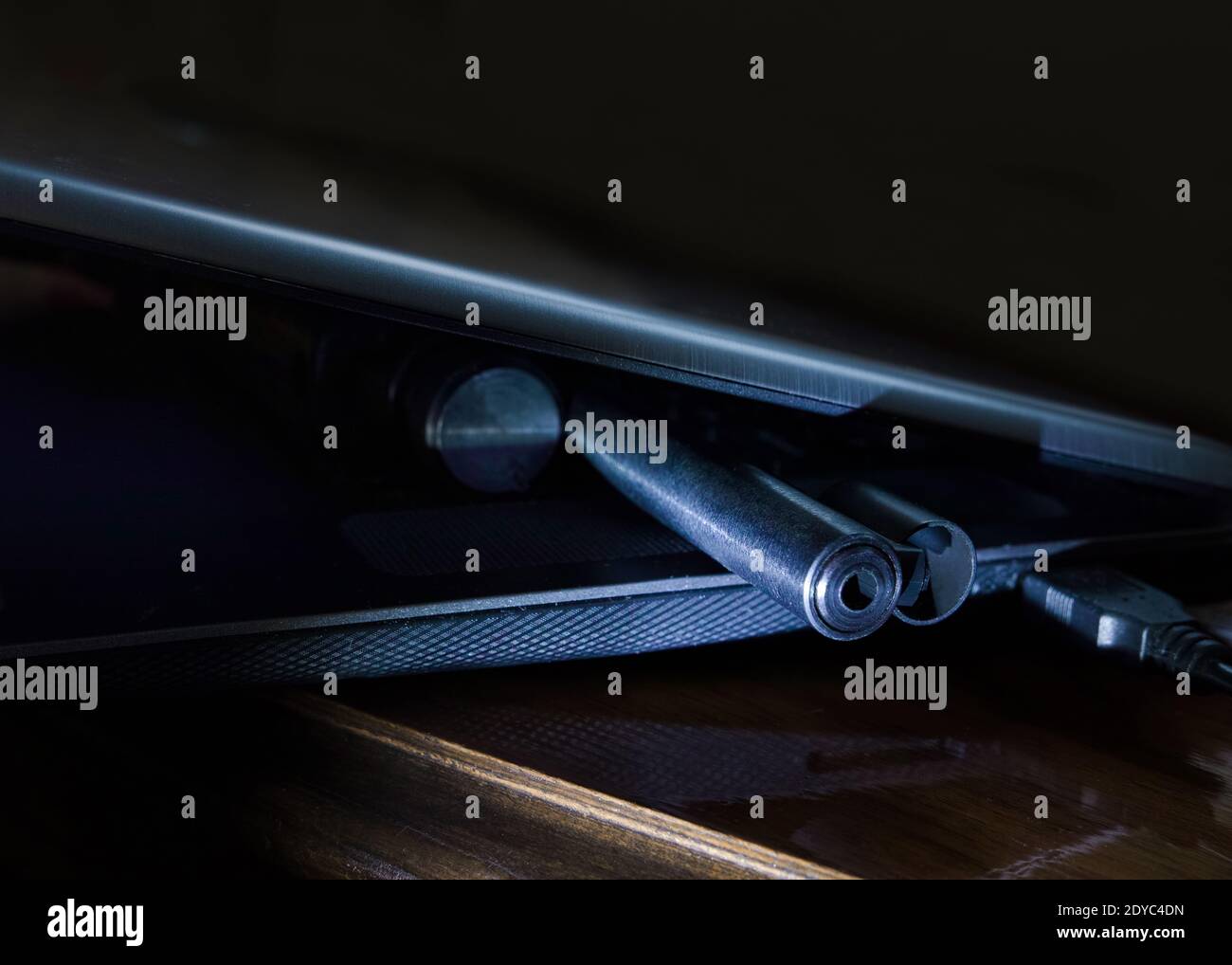 A partially folded laptop hides a weapon Stock Photo - Alamy
