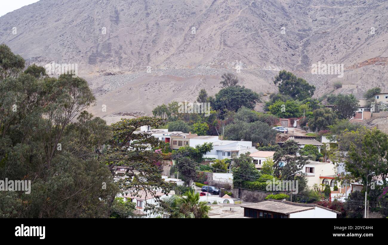 Houses and trees in desert landscape under mountains Lima peru Stock ...
