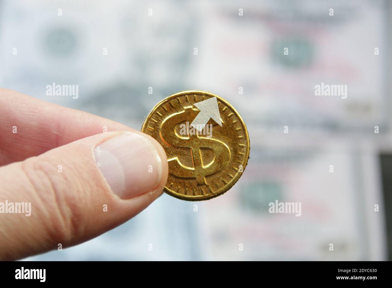 Profit growth creative idea. Creative concept. Hand holds a gold coin ...