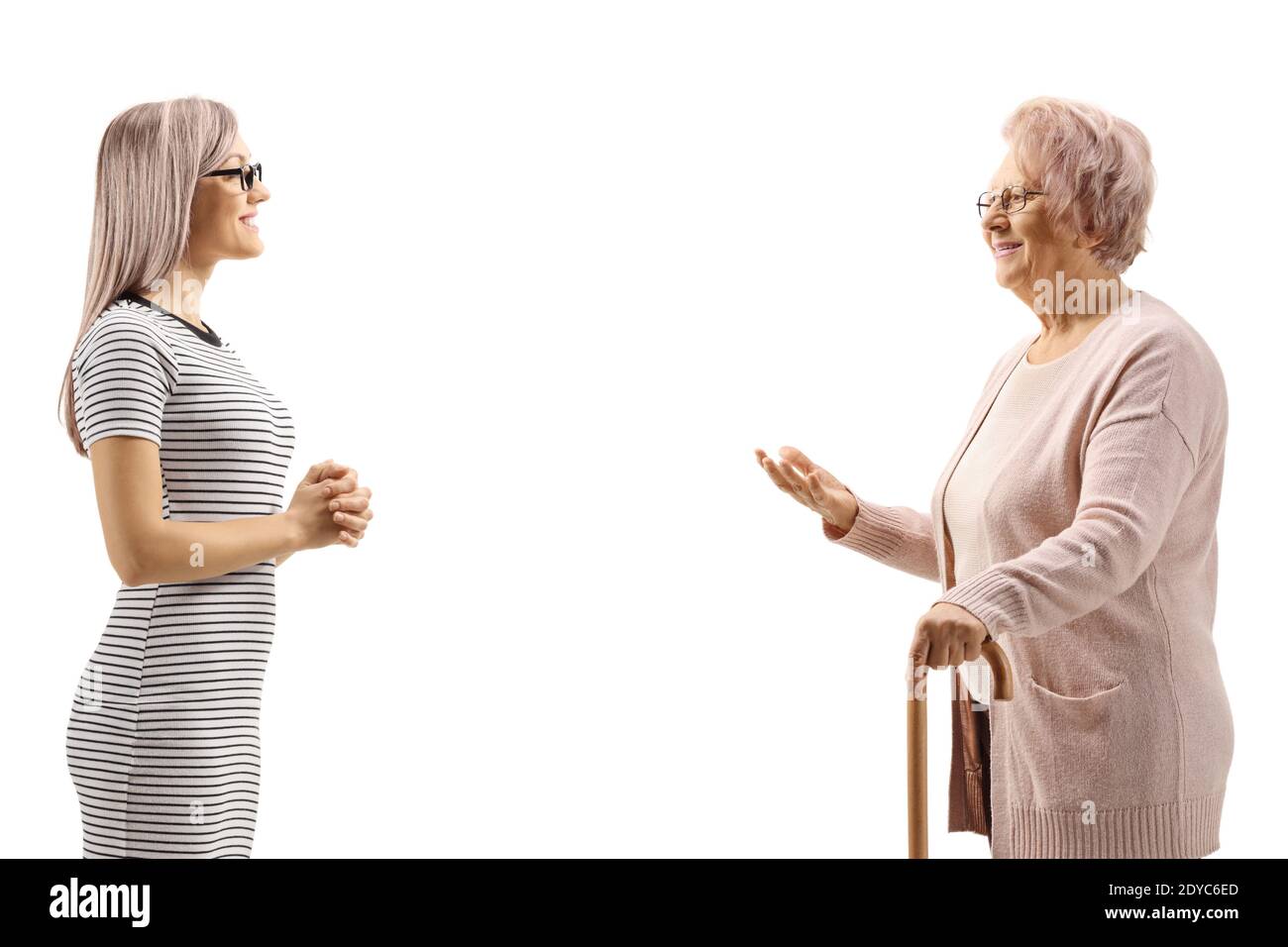Blond young woman listening to an older woman talking isolated on white ...