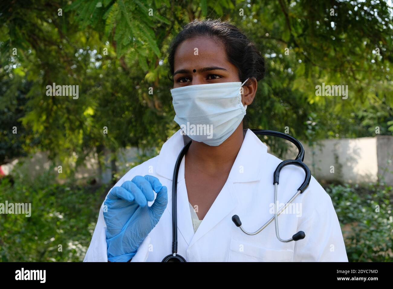 An Indian doctor with a stethoscope wearing a mask Stock Photo - Alamy